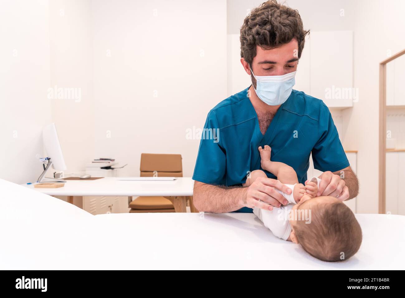 Photo with copy space of a doctor examining a newborn baby lying on a ...