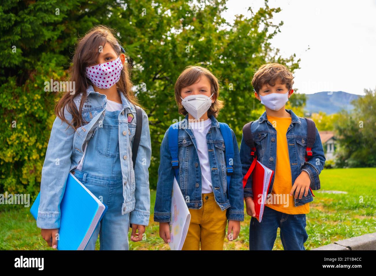 Three brothers with face masks ready to go back to school. New ...