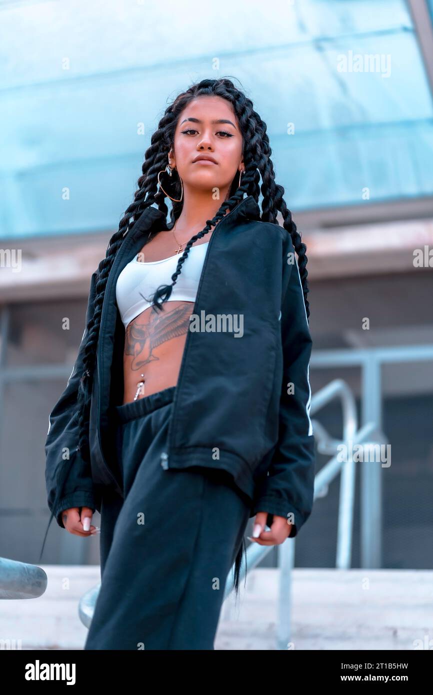 Urban session, with a young brunette of Latin ethnicity with braids ...