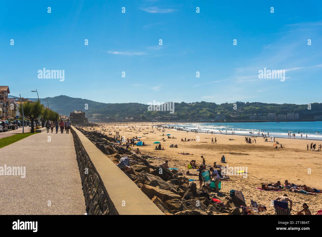 Hendaye beach one summer afternoon full of people enjoying the water in ...