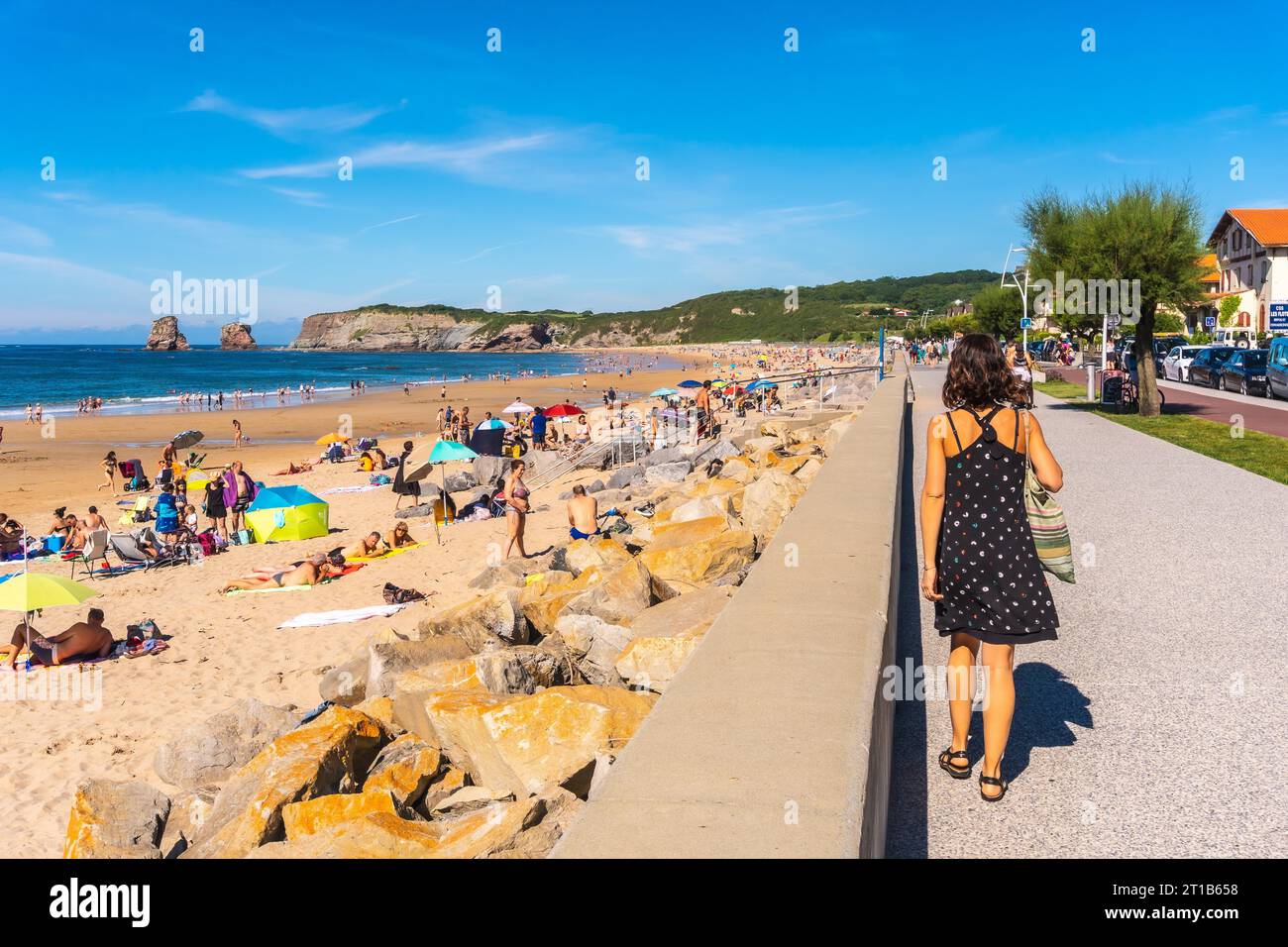 Hendaye beach one summer afternoon full of people enjoying the water in ...