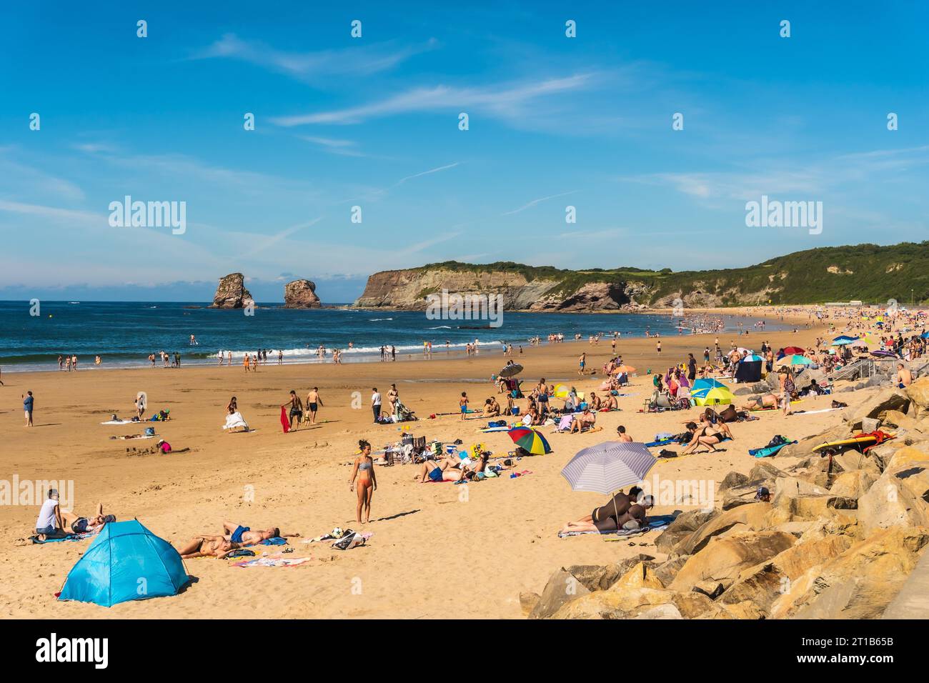 Hendaye beach one summer afternoon full of people enjoying the water in ...