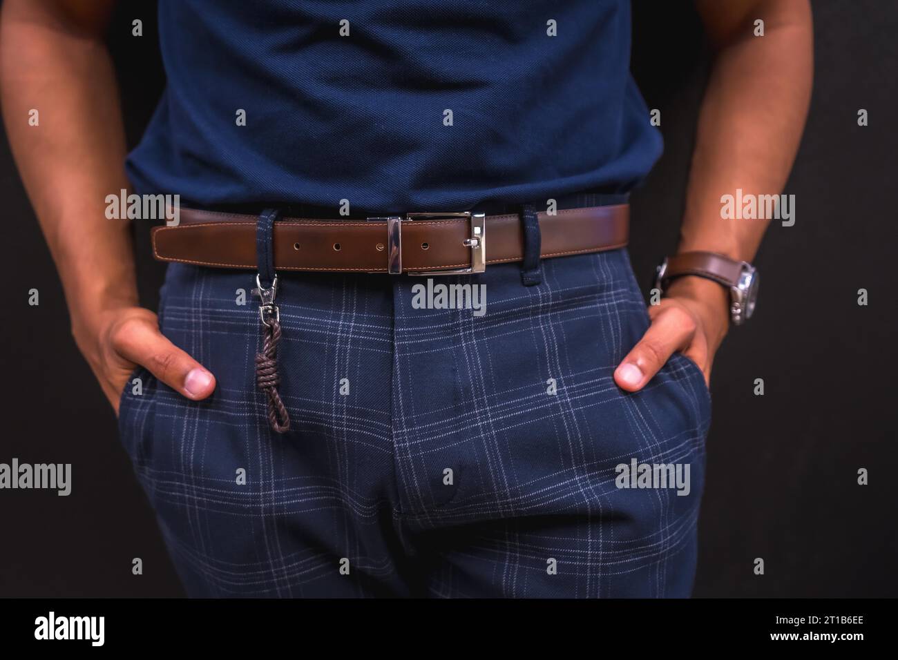Fashion lifestyle, portrait of a young Latino man on a black wall. Blue ...