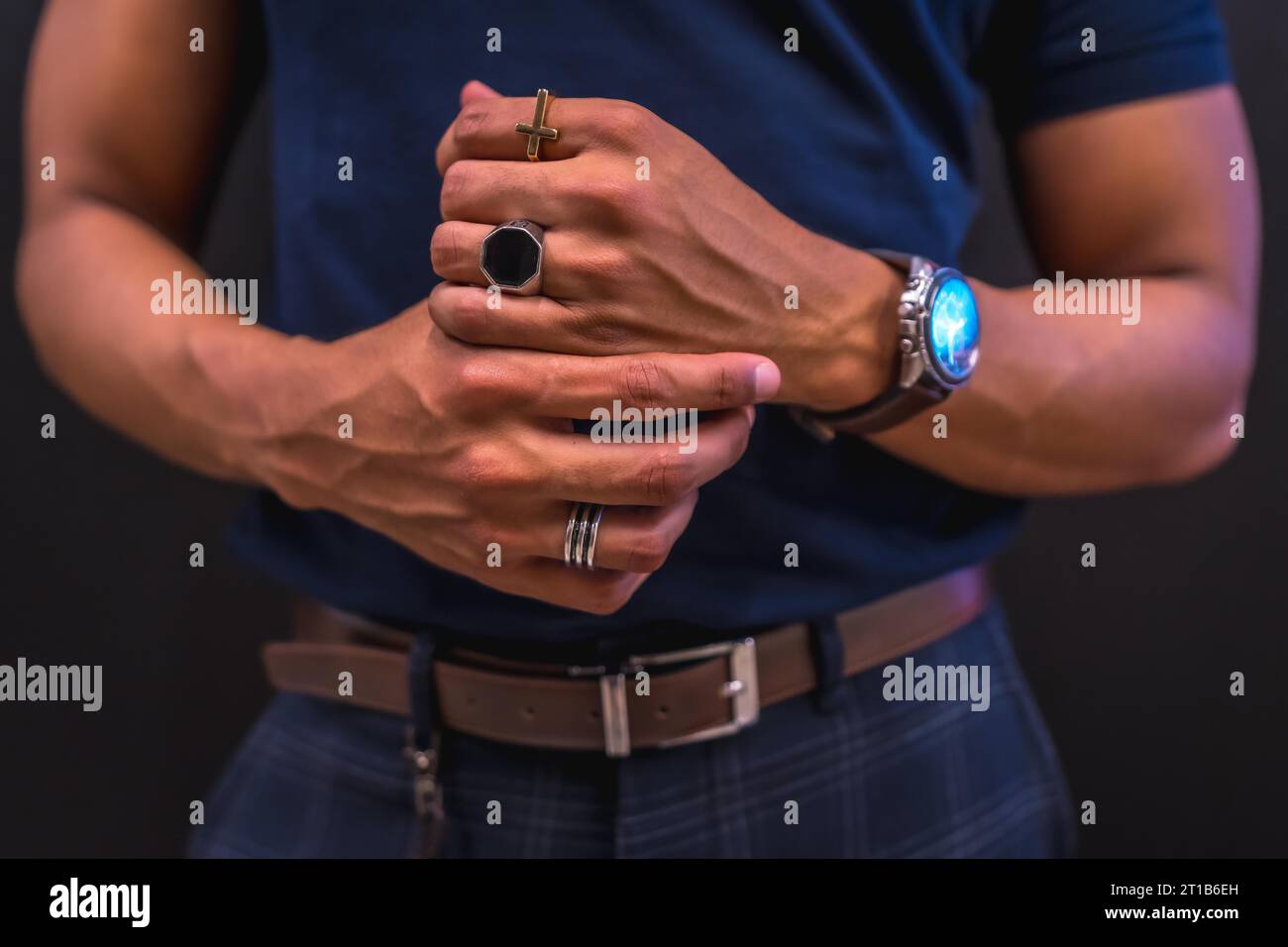 Fashion lifestyle, portrait of a young Latino man on a black wall. Blue ...