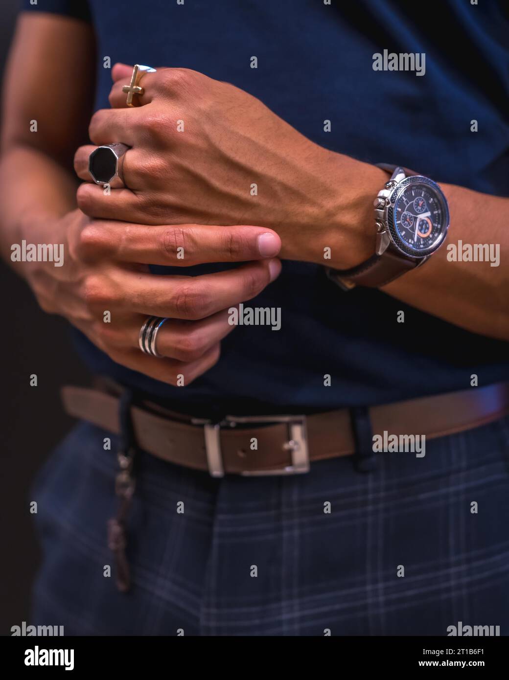 Fashion lifestyle, portrait of a young Latino man on a black wall. Blue ...
