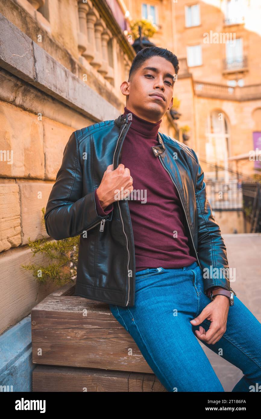 Fashion lifestyle, portrait of a Latino boy in the city. Jeans, leather ...