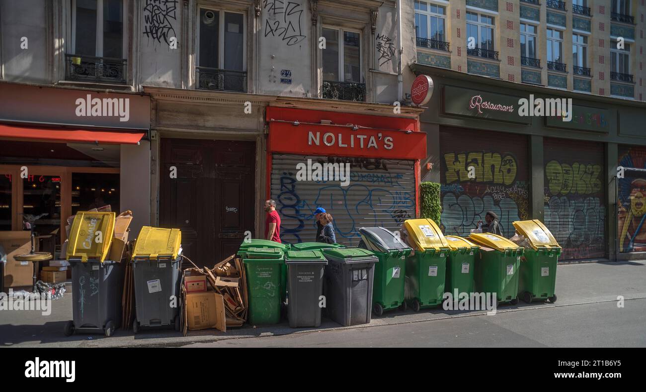 Full paper bins on the street ready for collection, Paris, France Stock ...