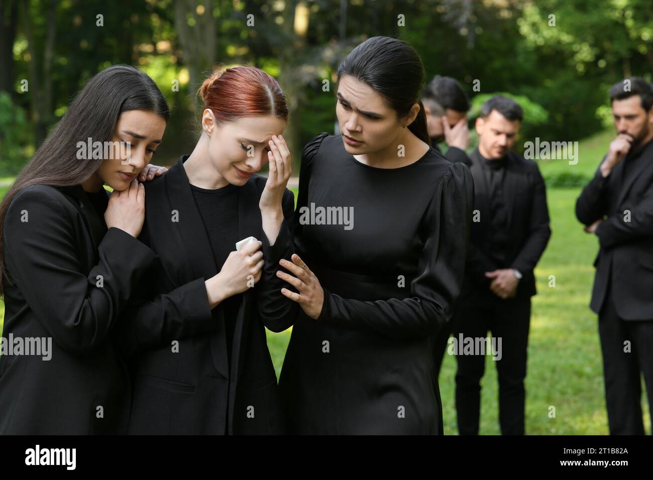 Sad people in black clothes mourning outdoors. Funeral ceremony Stock ...