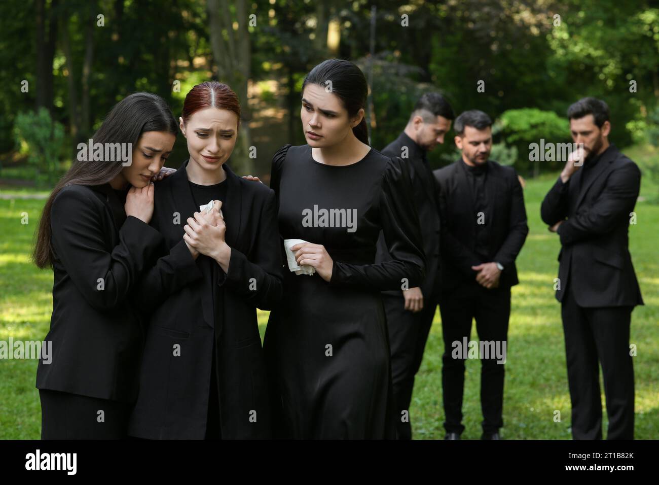 Sad people in black clothes mourning outdoors. Funeral ceremony Stock ...