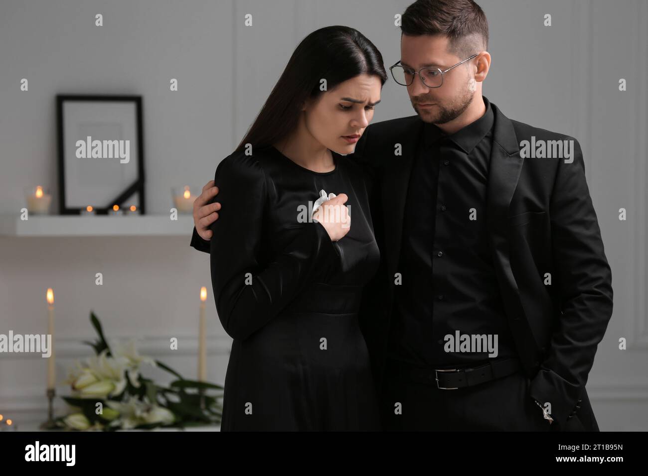 Sad couple mourning in room. Funeral ceremony Stock Photo - Alamy