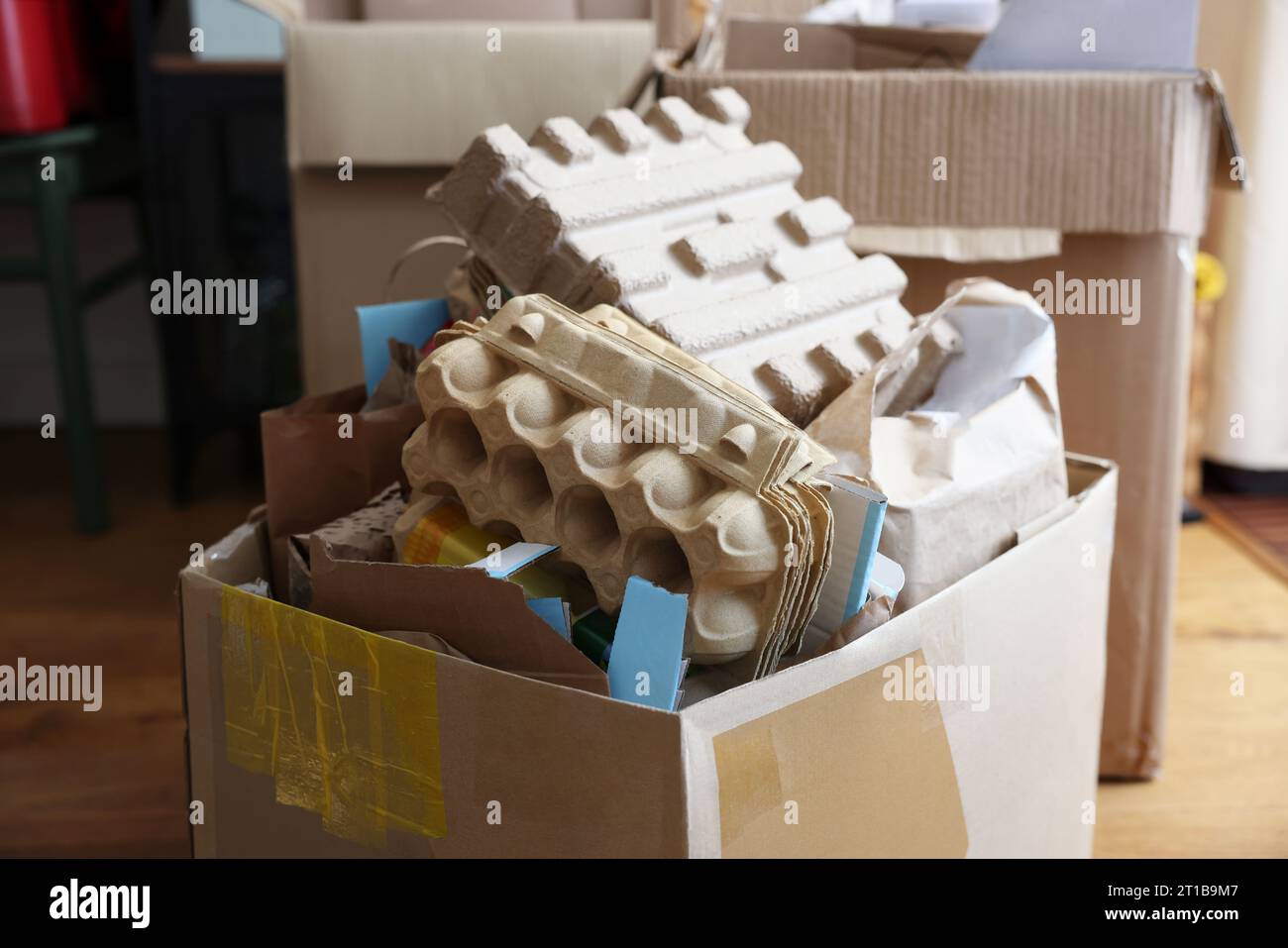 Reuse concept. Different trash in cardboard boxes for recycling indoors ...