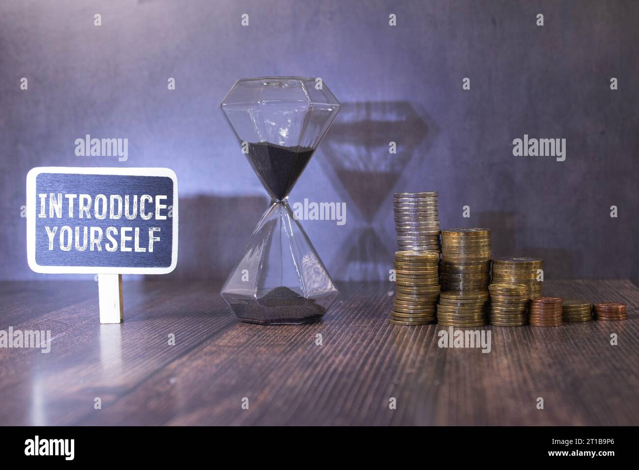 Sticky note with the text Introduce yourself on office desk. Self ...