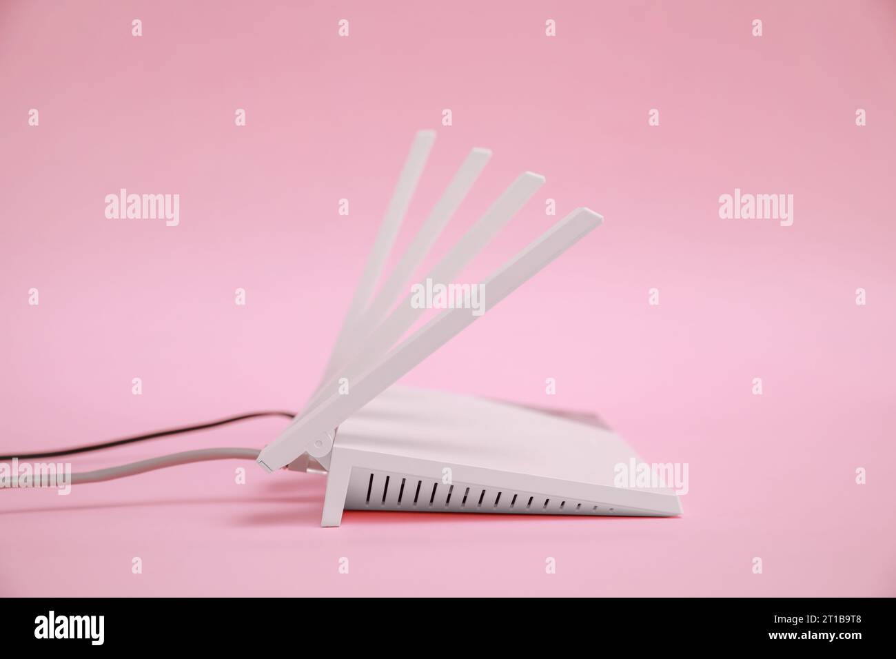 One modern Wi-Fi router on pink background Stock Photo - Alamy