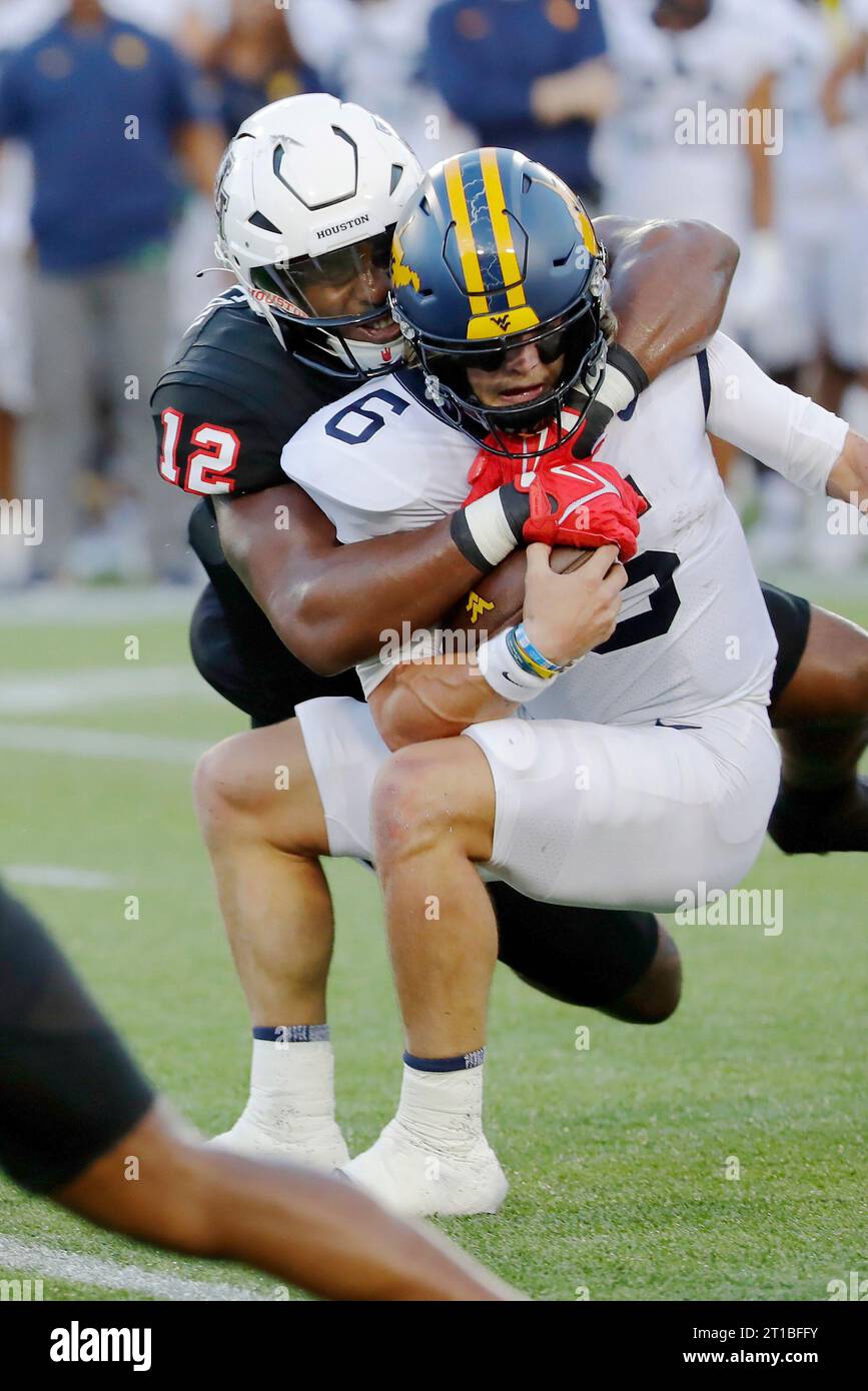 West Virginia quarterback Garrett Greene (6) is sacked by Houston ...