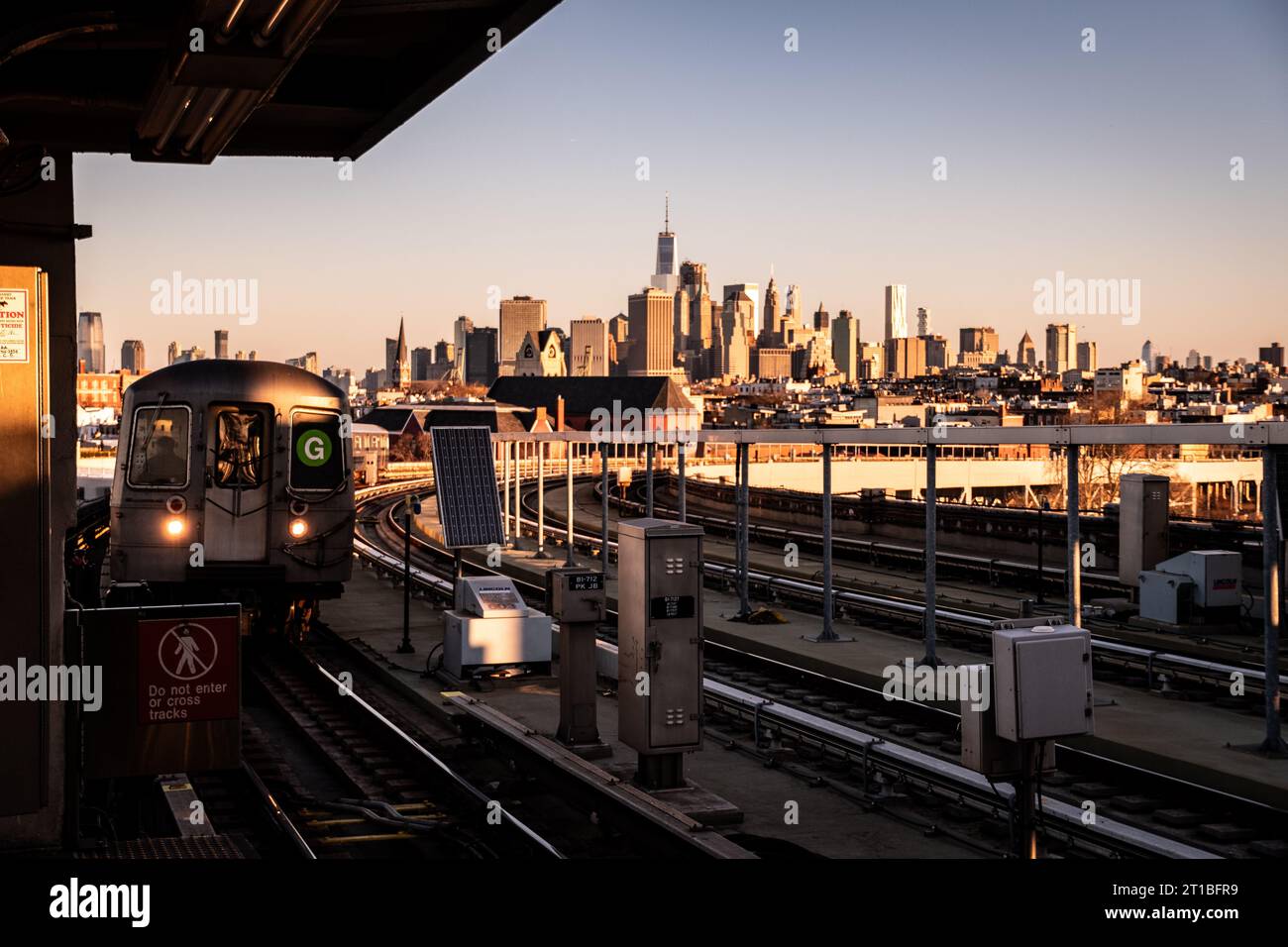 Golden hour view of New York City skyline and an approaching G train at ...