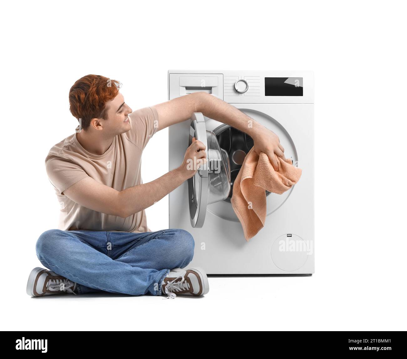 Young man putting on clothes Cut Out Stock Images & Pictures - Alamy