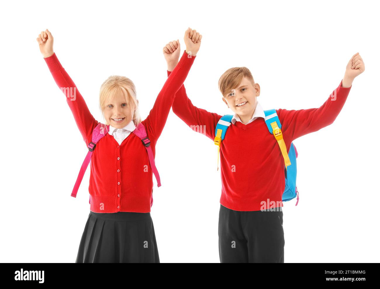 Little classmates in stylish uniform with backpacks isolated on white ...