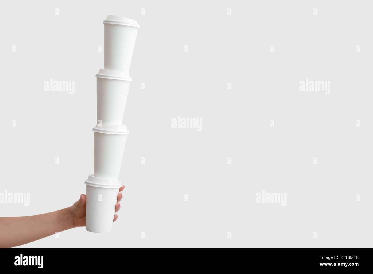 Female hand with stack of takeaway paper cups on white background Stock ...
