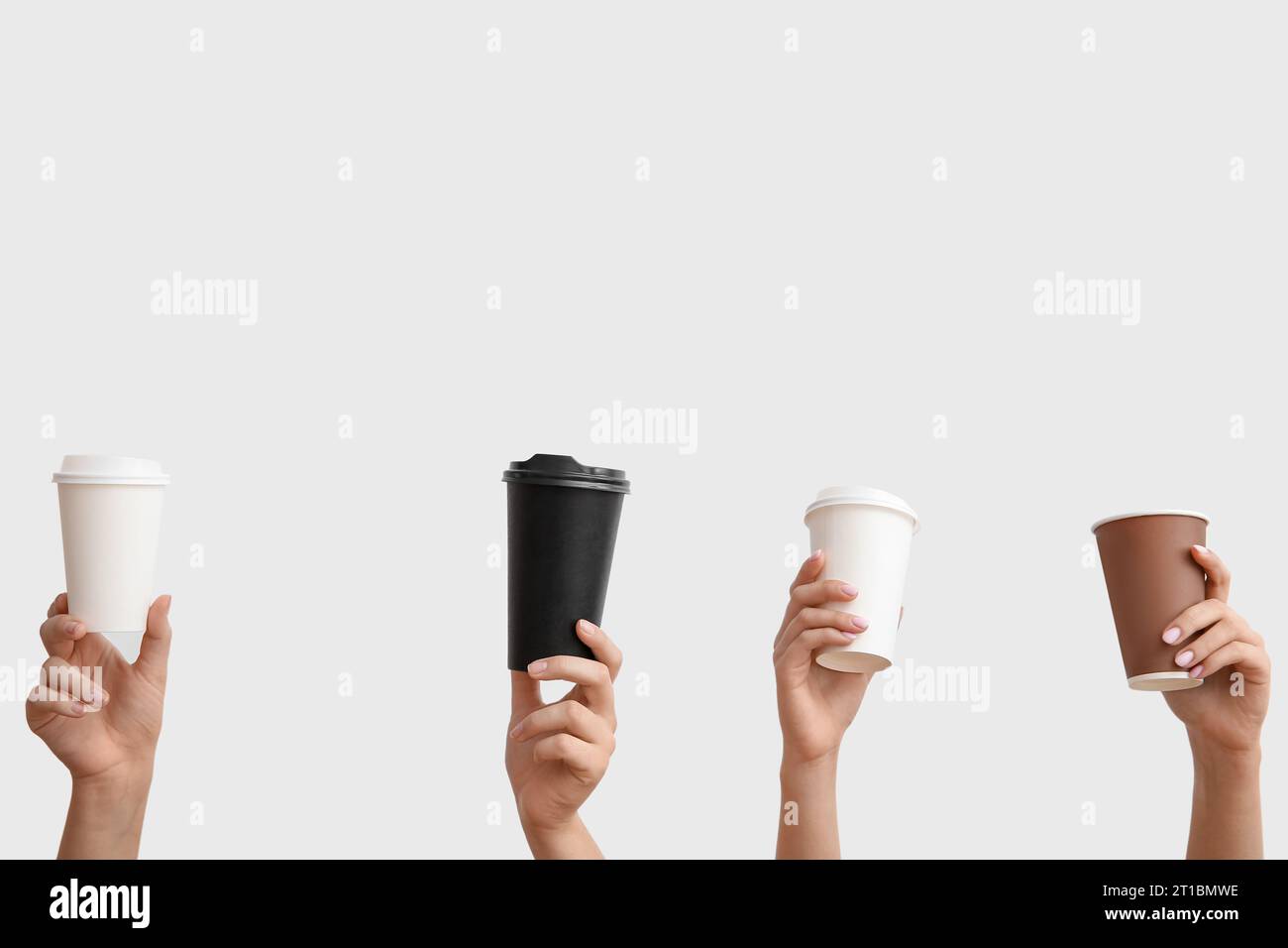 Female hands with different takeaway paper cups on white background ...