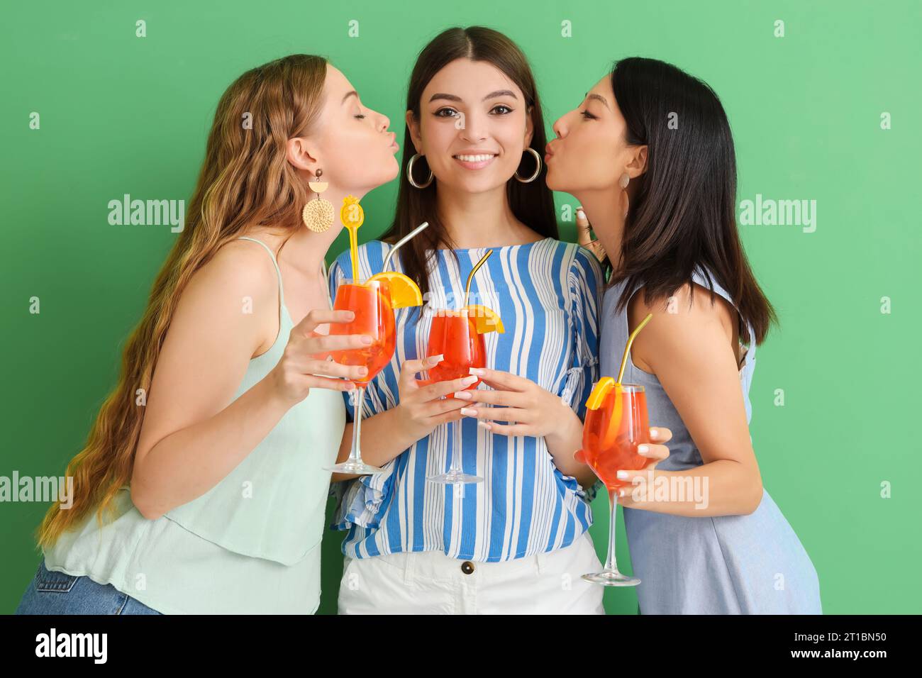 Beautiful young women with glasses of tasty aperol spritz cocktail on ...