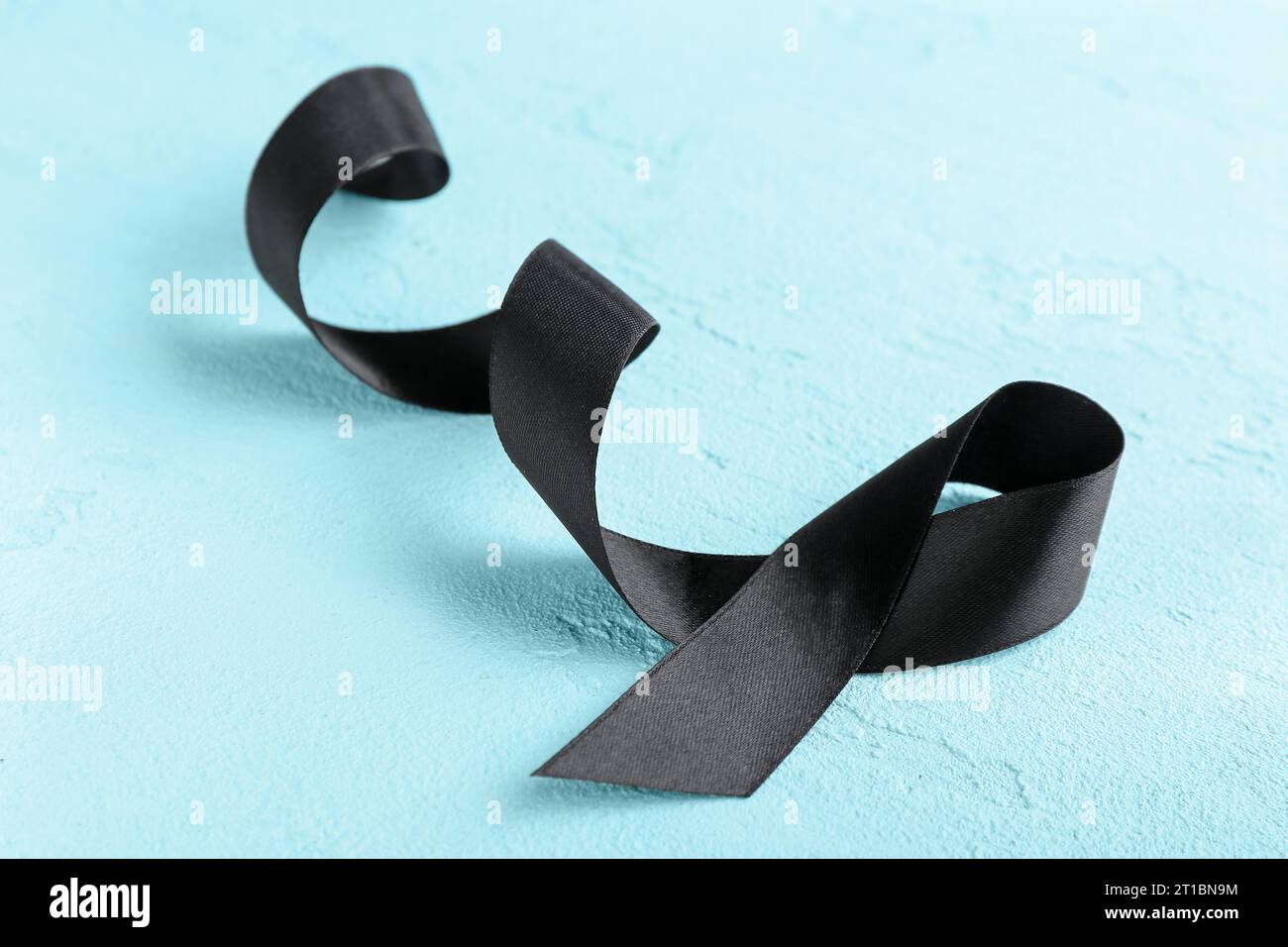 Black funeral ribbon on blue background Stock Photo - Alamy