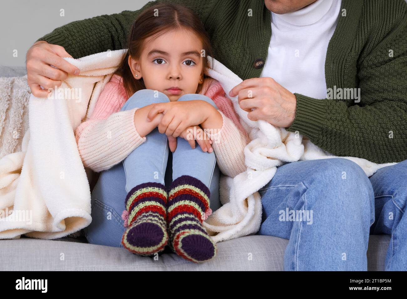 Frozen little girl and her father with lack of heating at home Stock ...