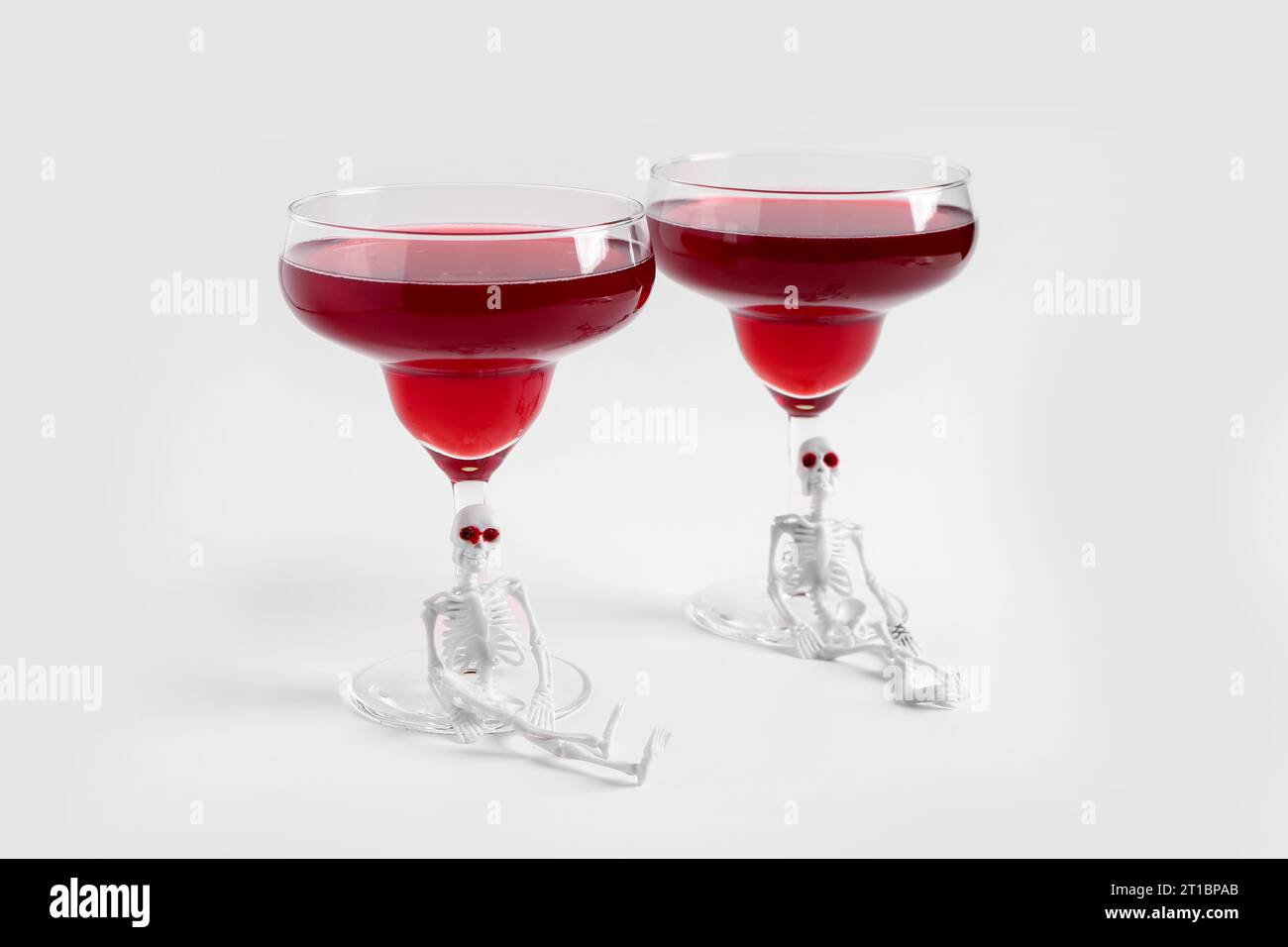 Glasses of delicious cocktail with skeletons for Halloween celebration ...