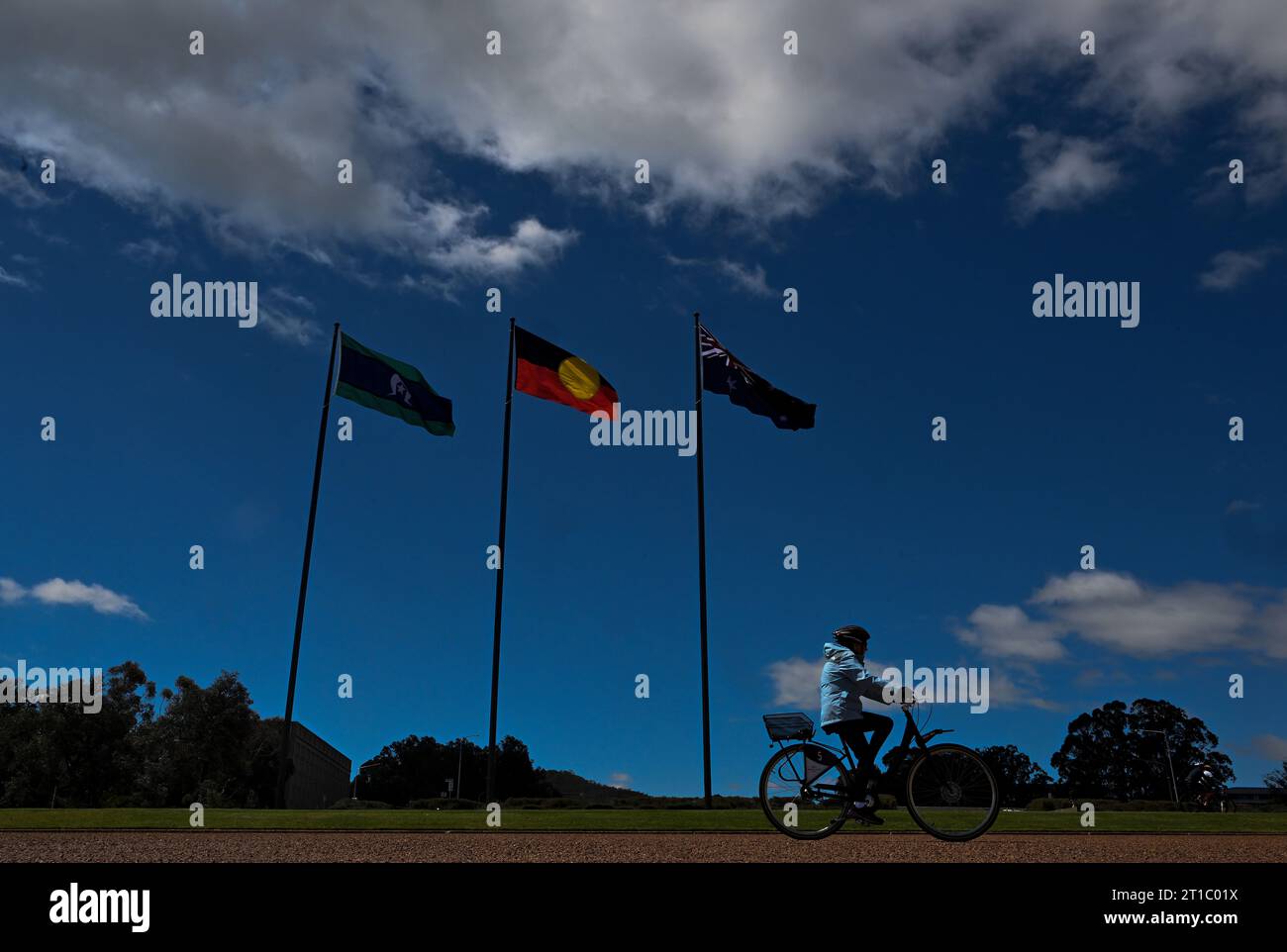 Canberra, Australia. 13th Oct, 2023. A woman rides her bike past the ...