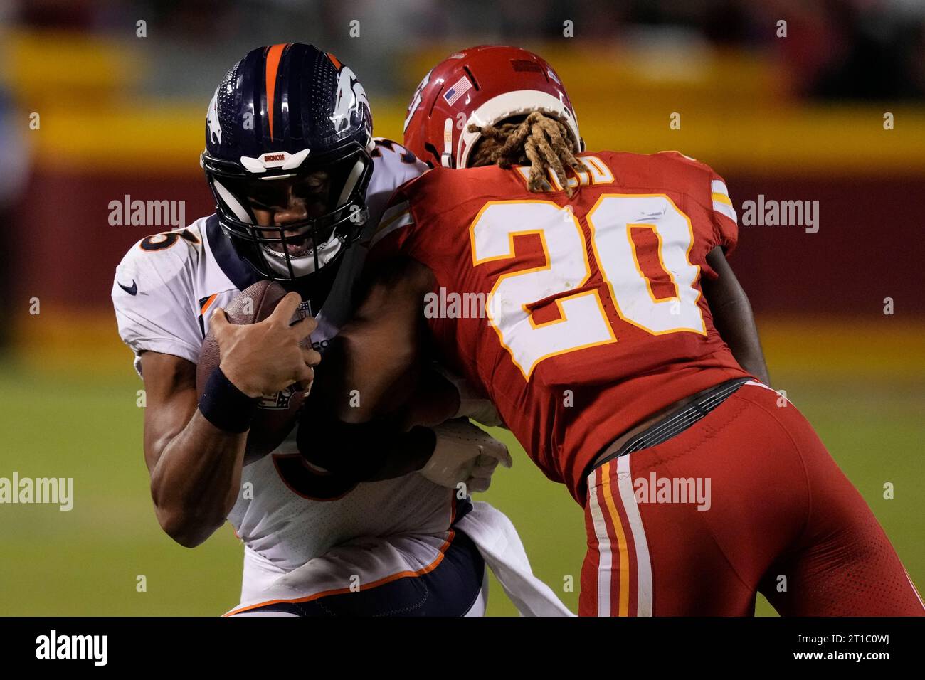 Denver Broncos quarterback Russell Wilson (3) is tackled by Kansas City ...