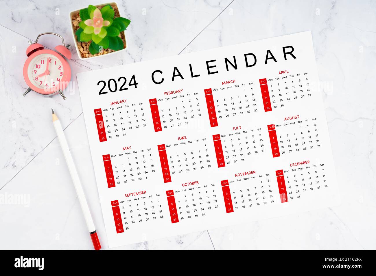 12 months calendar page for 2024 year page and pencil with alarm clock ...