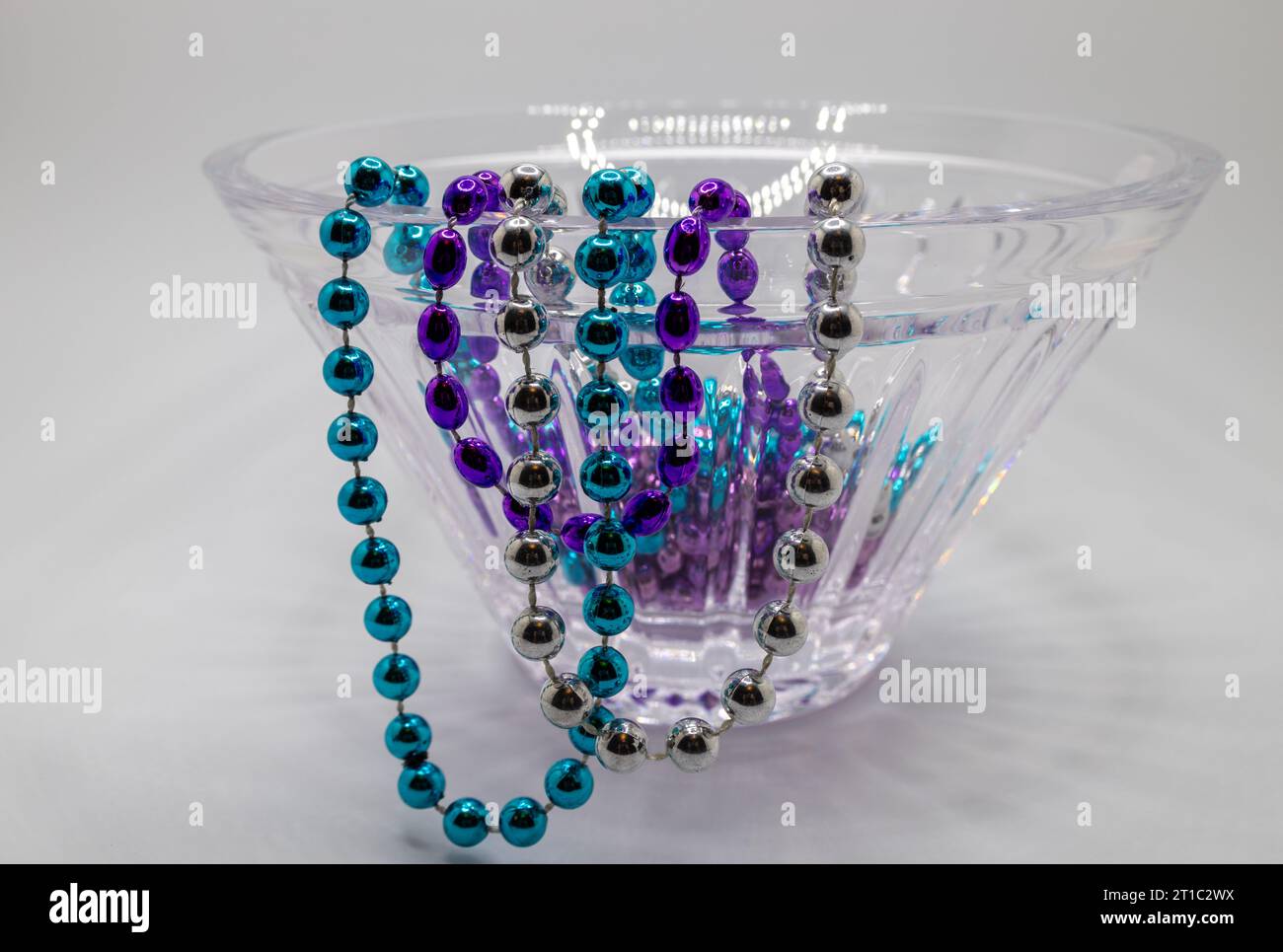 Close up view of a modern lead crystal glass bowl draped with colorful ...