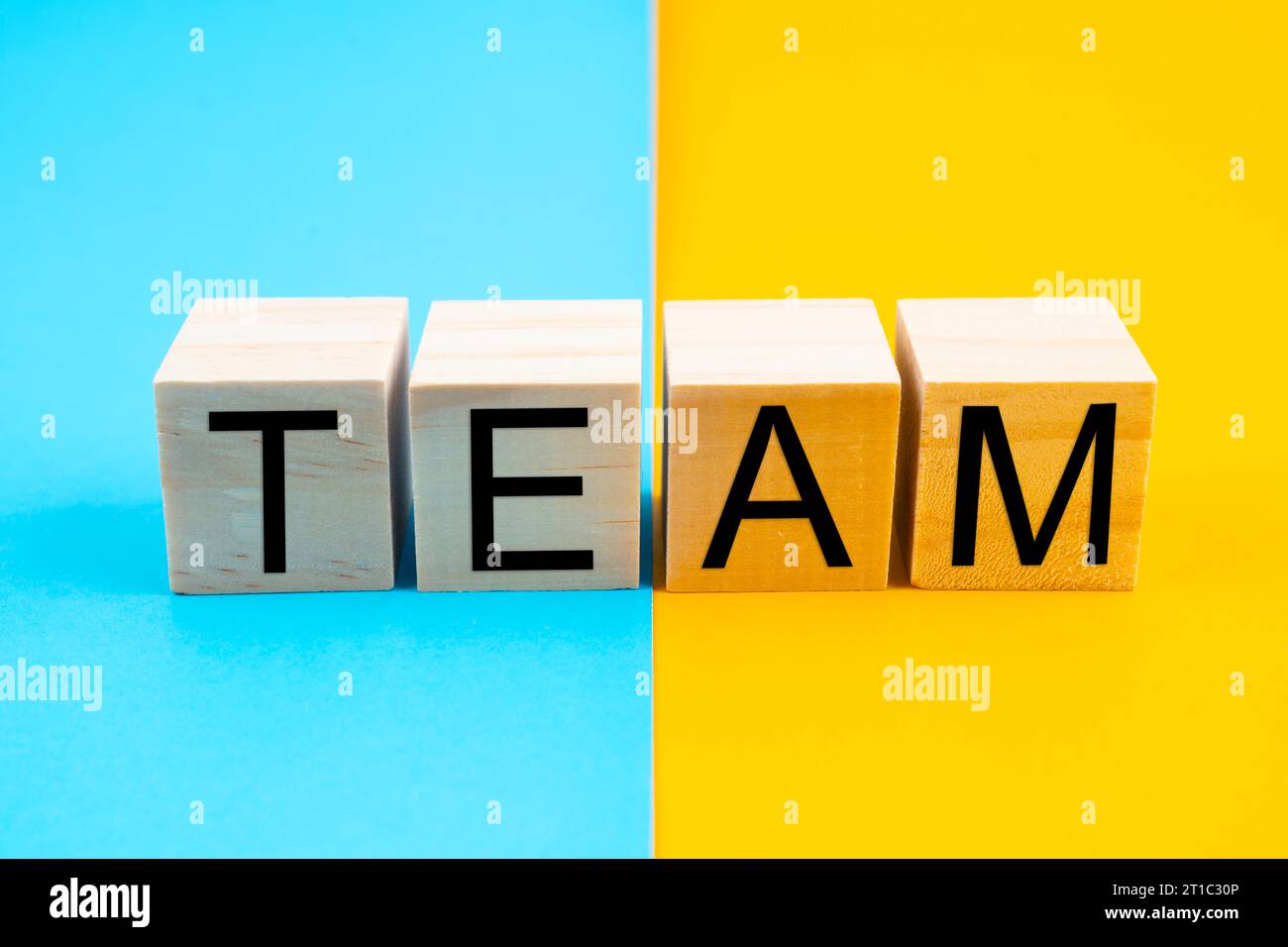 Word team is standing in black letters on wooden cubes, different ...