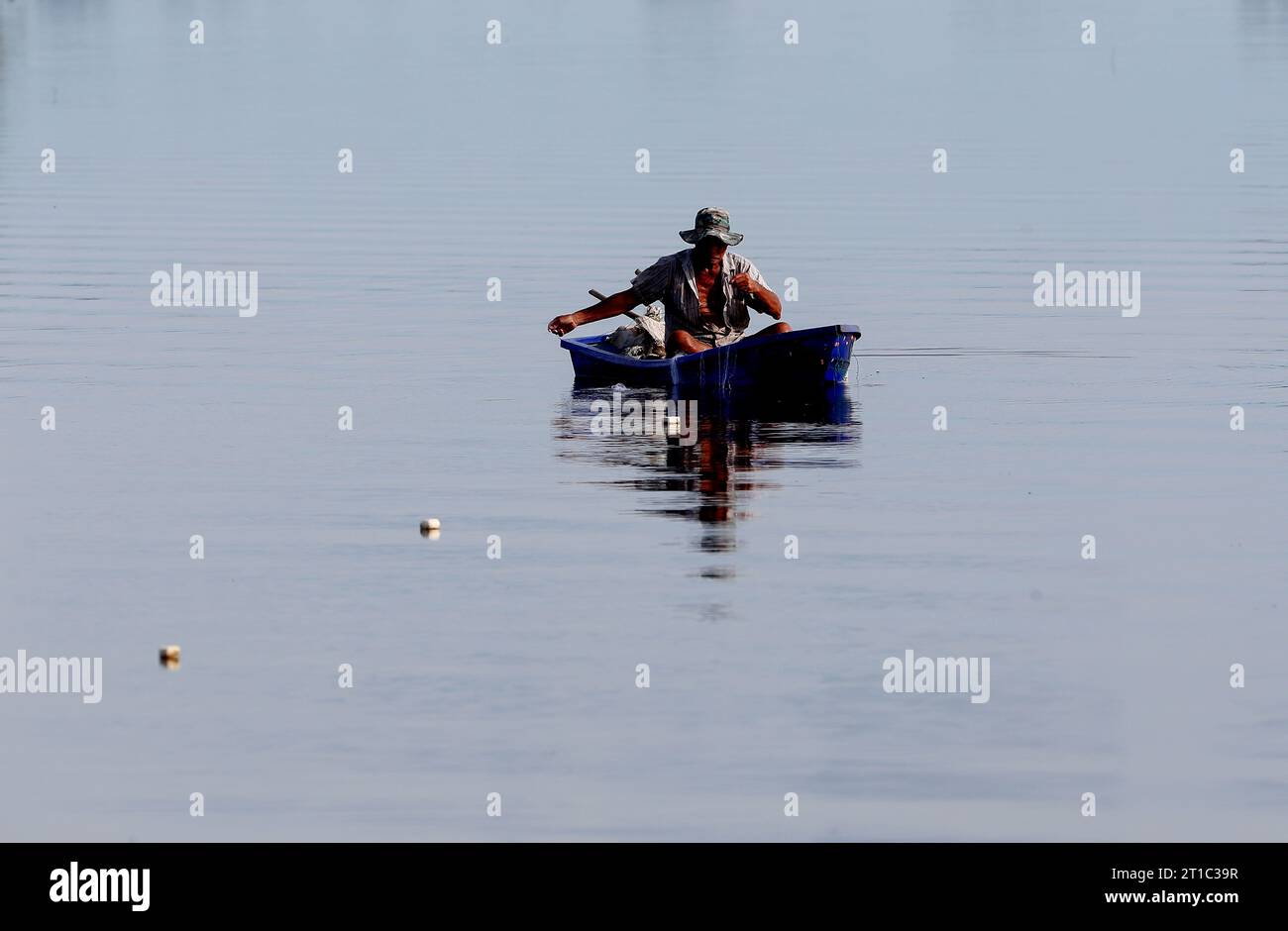 Nakhon Sawan, Thailand. 12th Oct, 2023. A villager rows a boat along a flooded rice field, in ...
