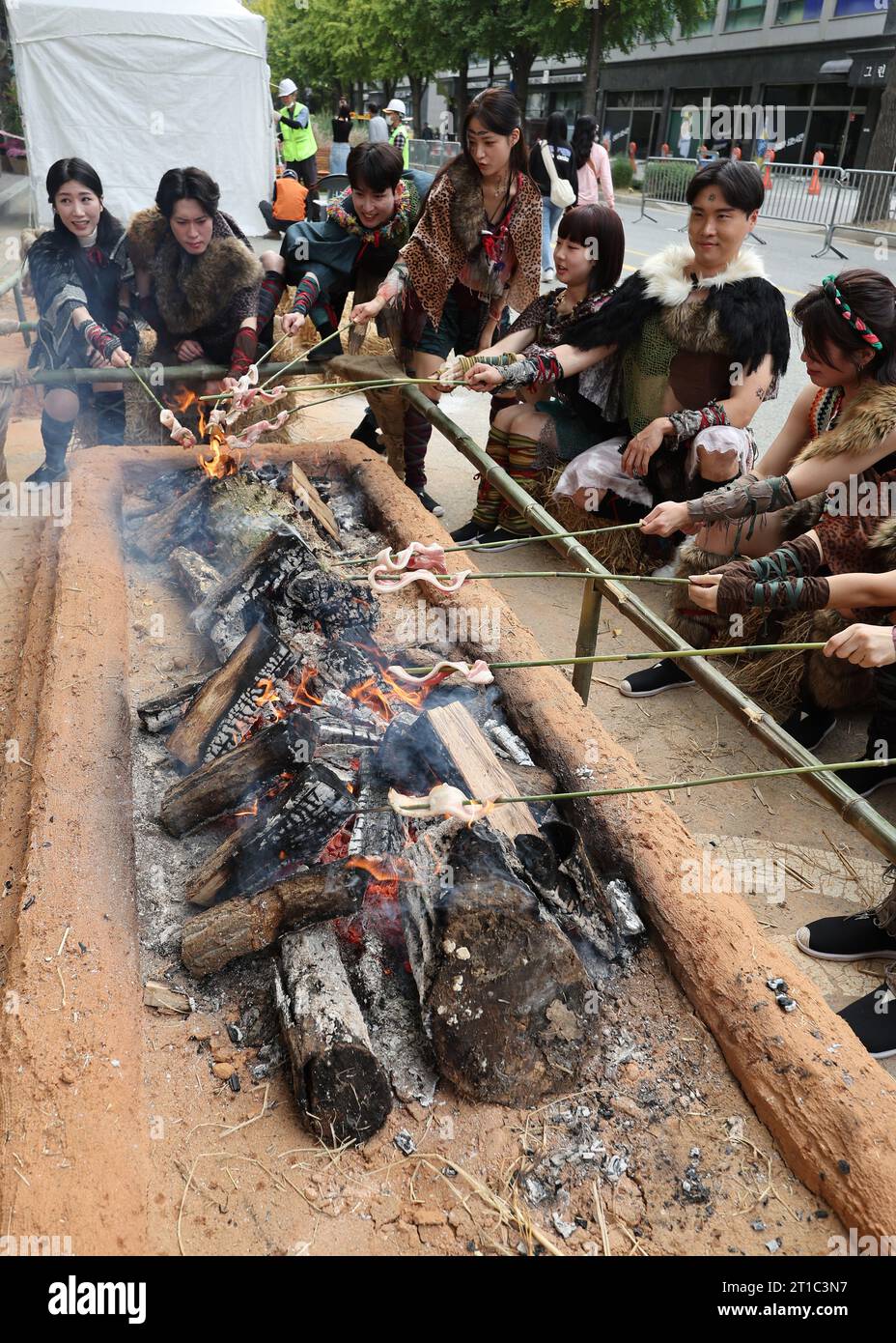 13th Oct, 2023. Prehistoric culture festival People have a barbecue as ...