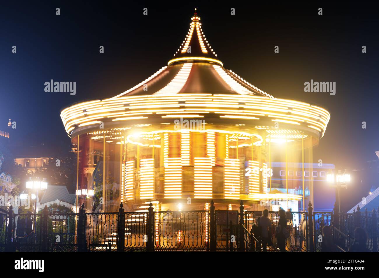 illuminated retro carousel rotate at night. classic carousel in rotary ...