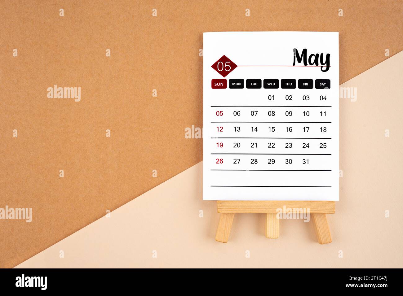 May 2024 calendar page on brown background Stock Photo - Alamy
