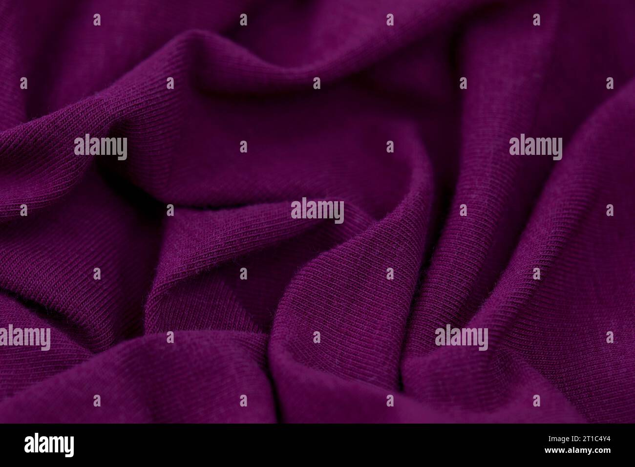 An abstract dark purple fabric texture background with distressed lines ...