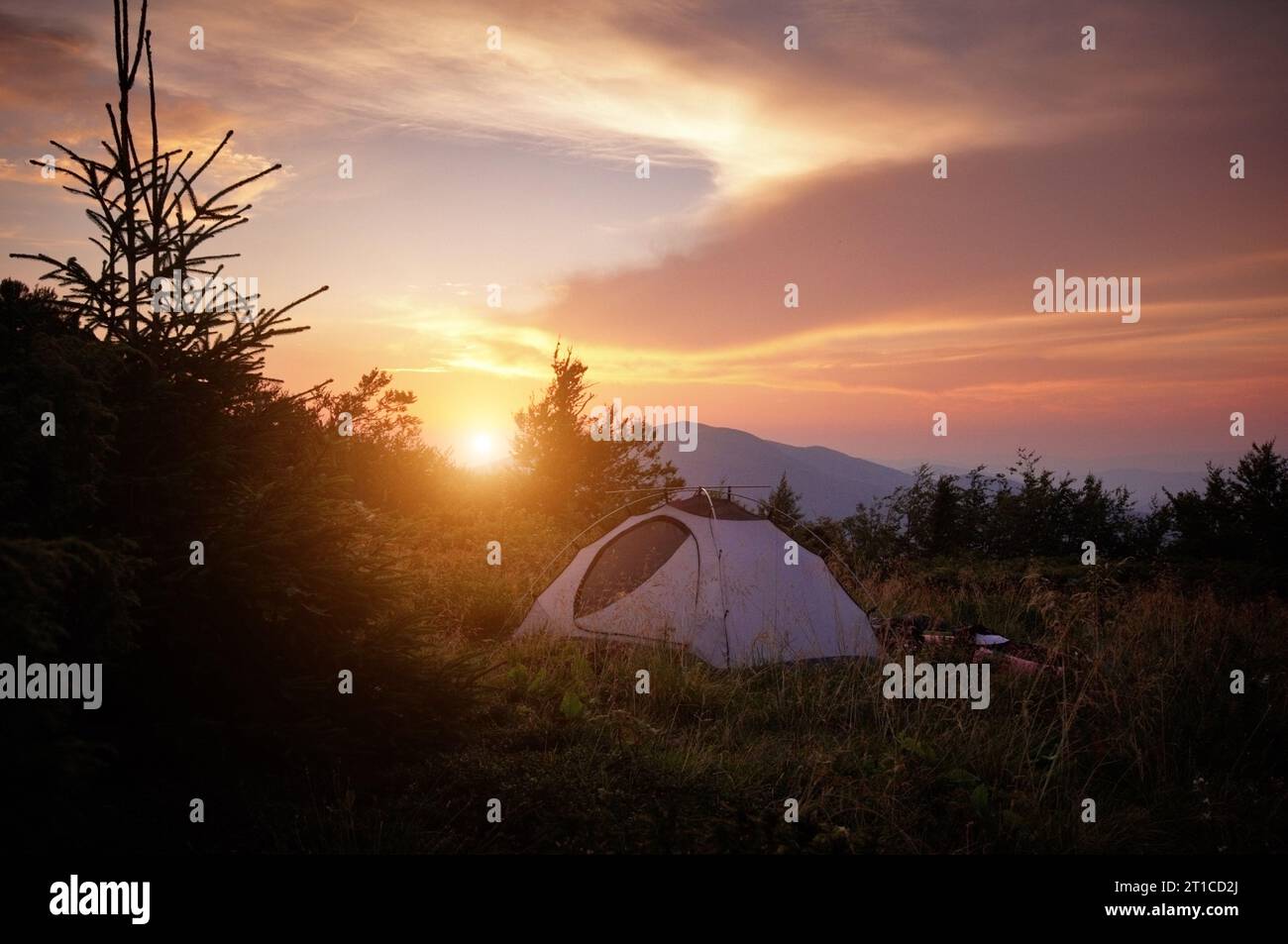 Tent on the mountain in the morning with the flare of sunrise Stock ...
