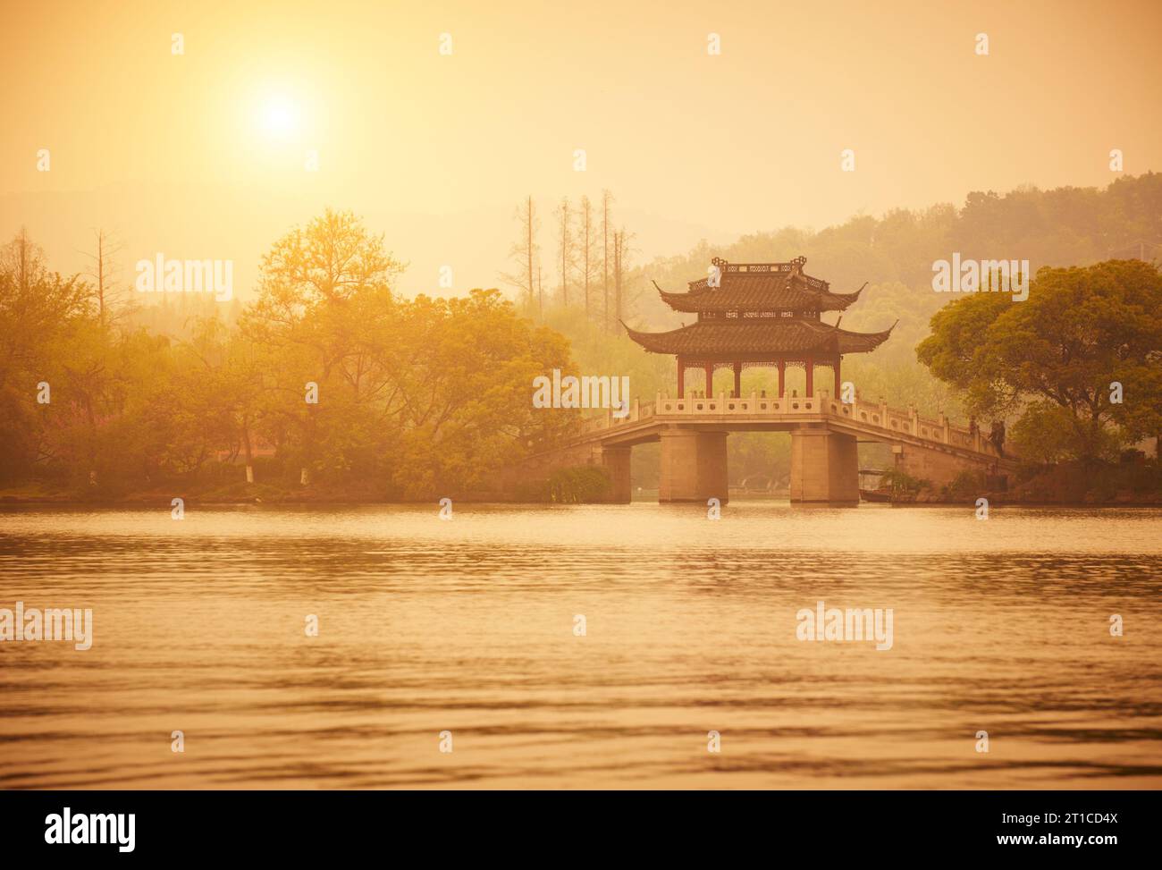 Traditional style pavilion and bridge at XiHu West Lake at sunset ...