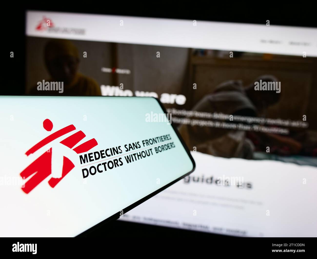 Cellphone with logo of charity organization Doctors Without Borders in front of website. Focus ...