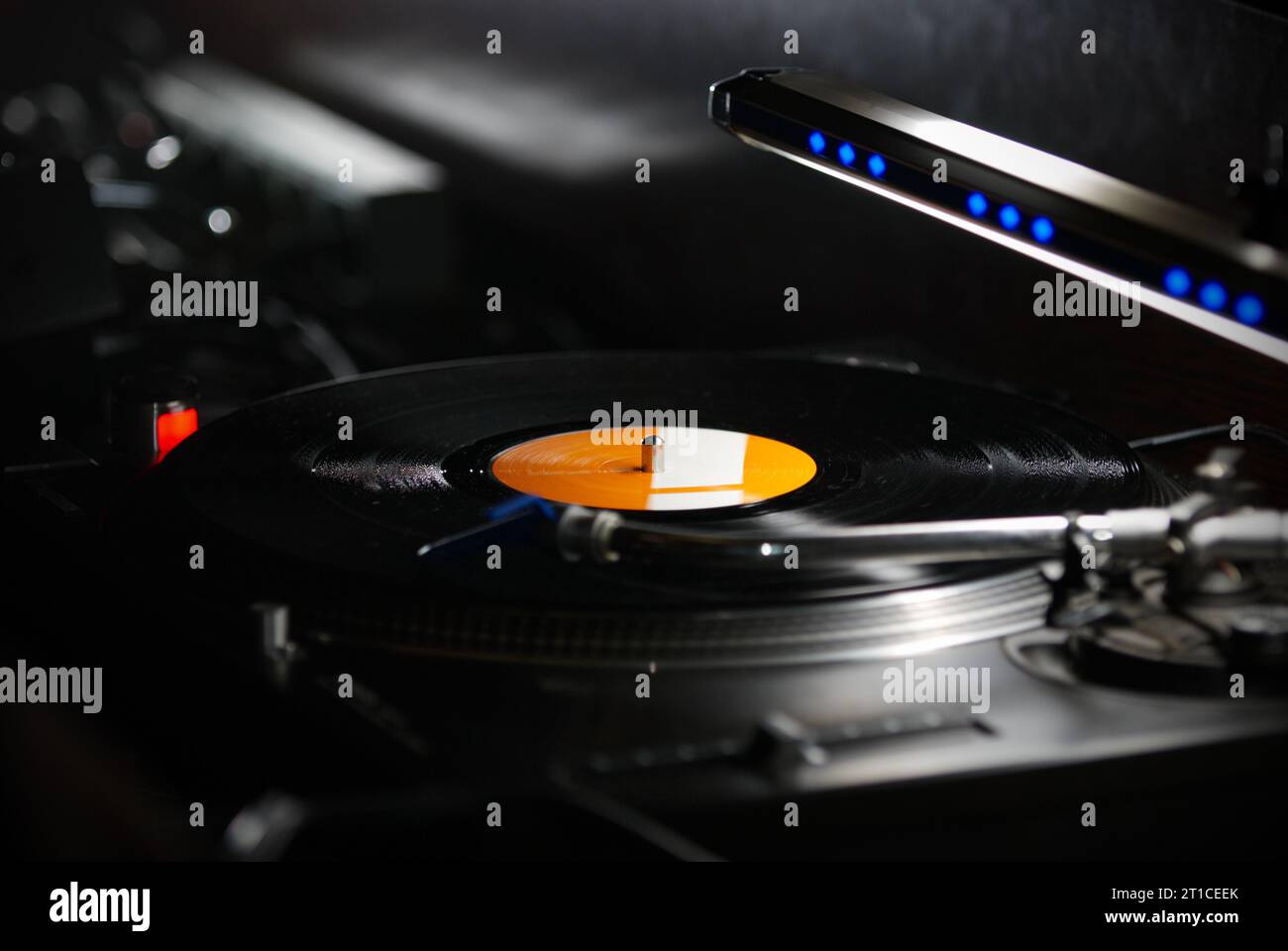 Dj turntables needle cartridge on black vinyl record with music. Close ...
