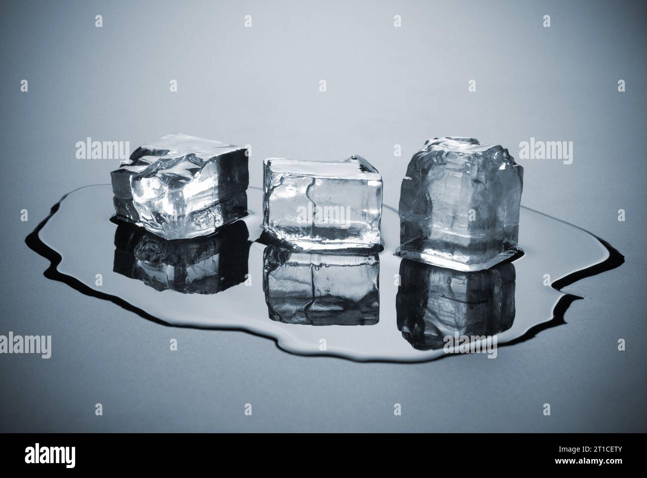 group of melted ice cubes with water puddle Stock Photo - Alamy