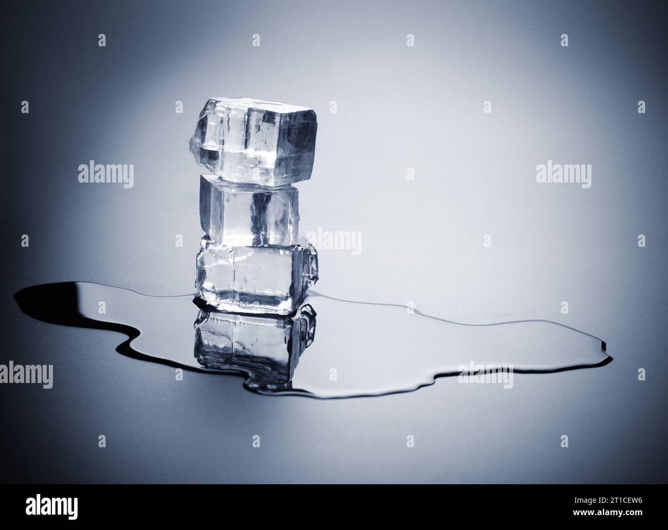 Pyramid of melted ice cubes with water puddle Stock Photo - Alamy