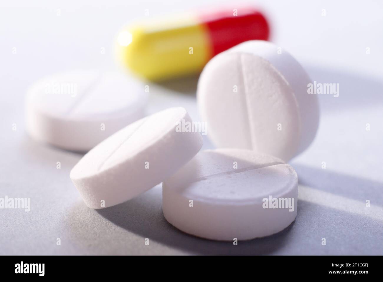 white drugs with yellow red capsules on white background close up Stock ...