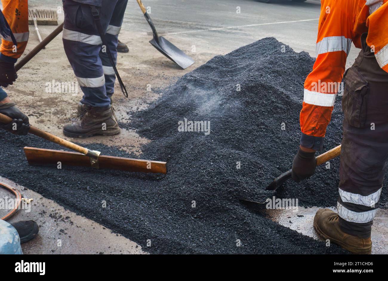 Road resurfacing. Fresh asphalt construction. Workers repairing the ...
