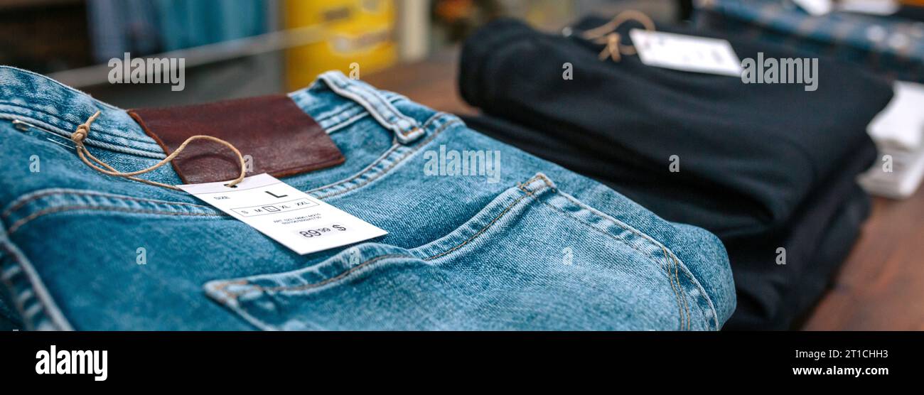Detail of label with price and size over a blue jeans pants on ...