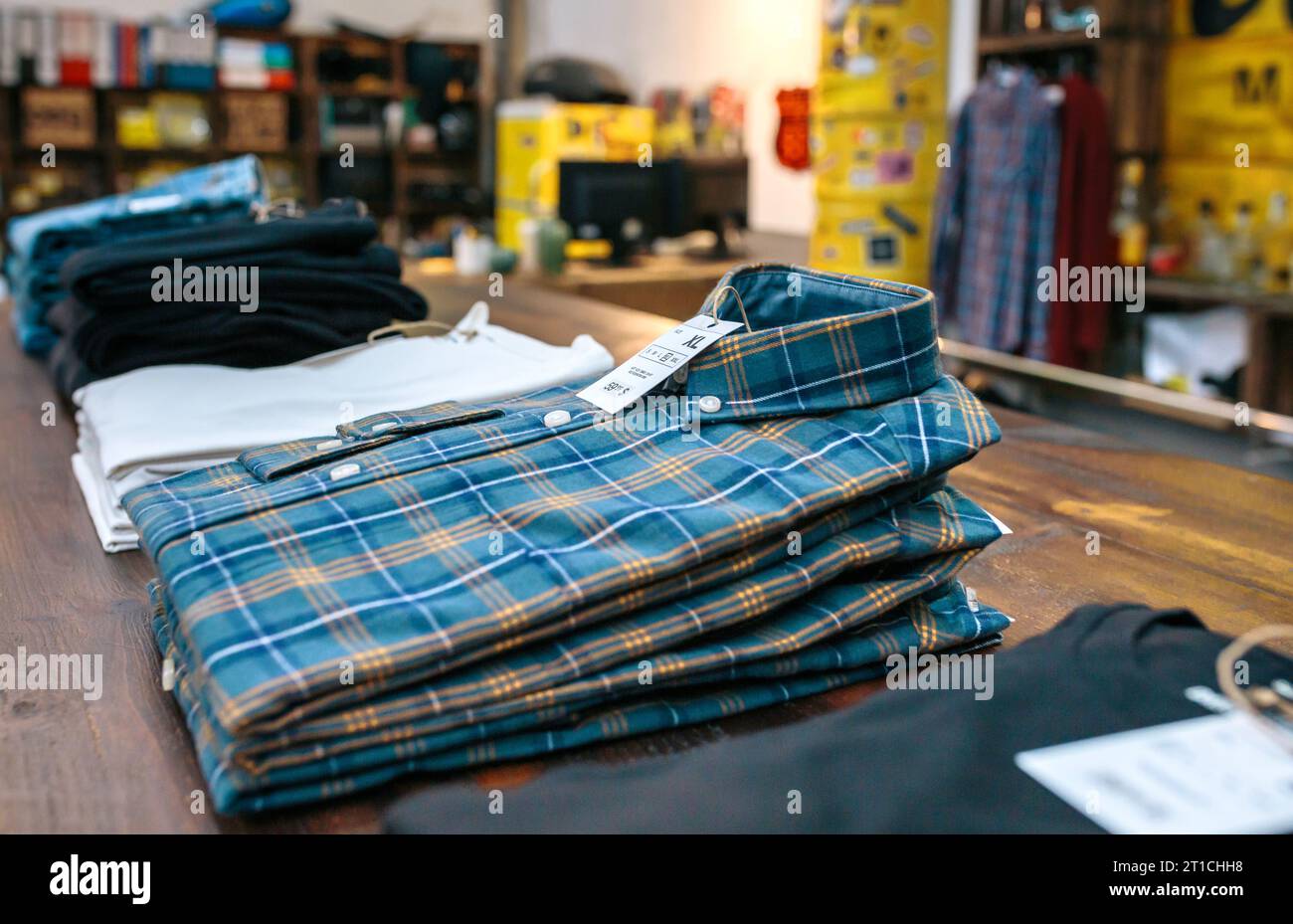 Organized blue plaid shirt stack over counter on vintage clothes shop ...
