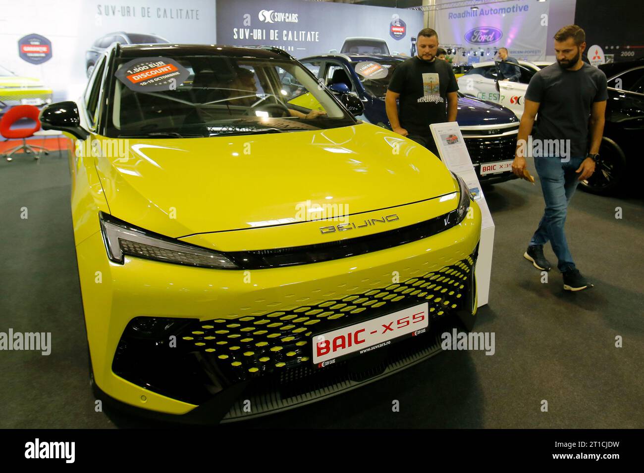 Bucharest, Romania. 12th Oct, 2023. Visitors look at a BAIC X55 car ...