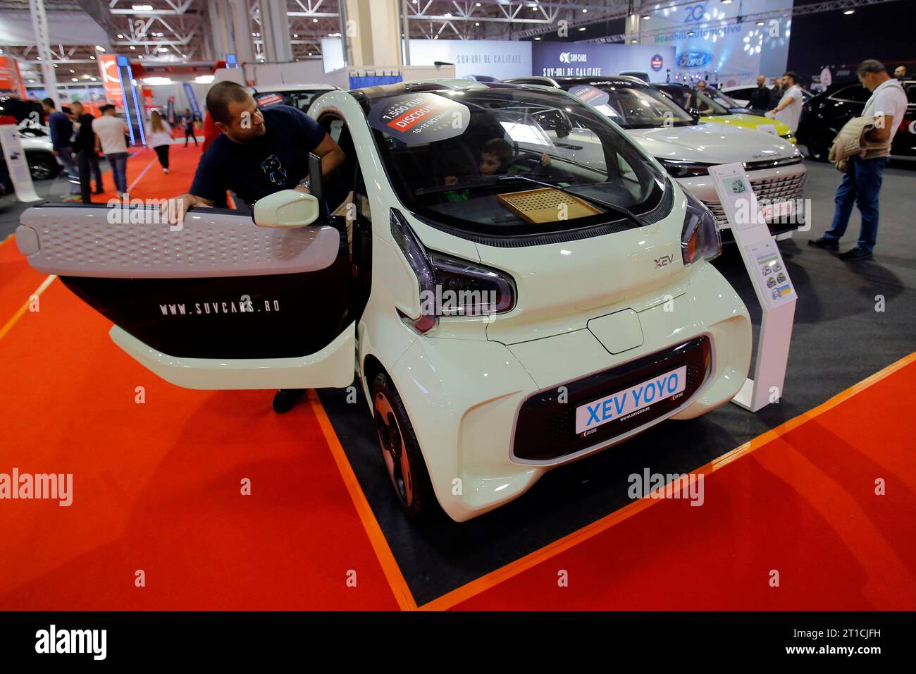Bucharest, Romania. 12th Oct, 2023. Visitors look at an XEV YOYO electric car?during the 20th ...