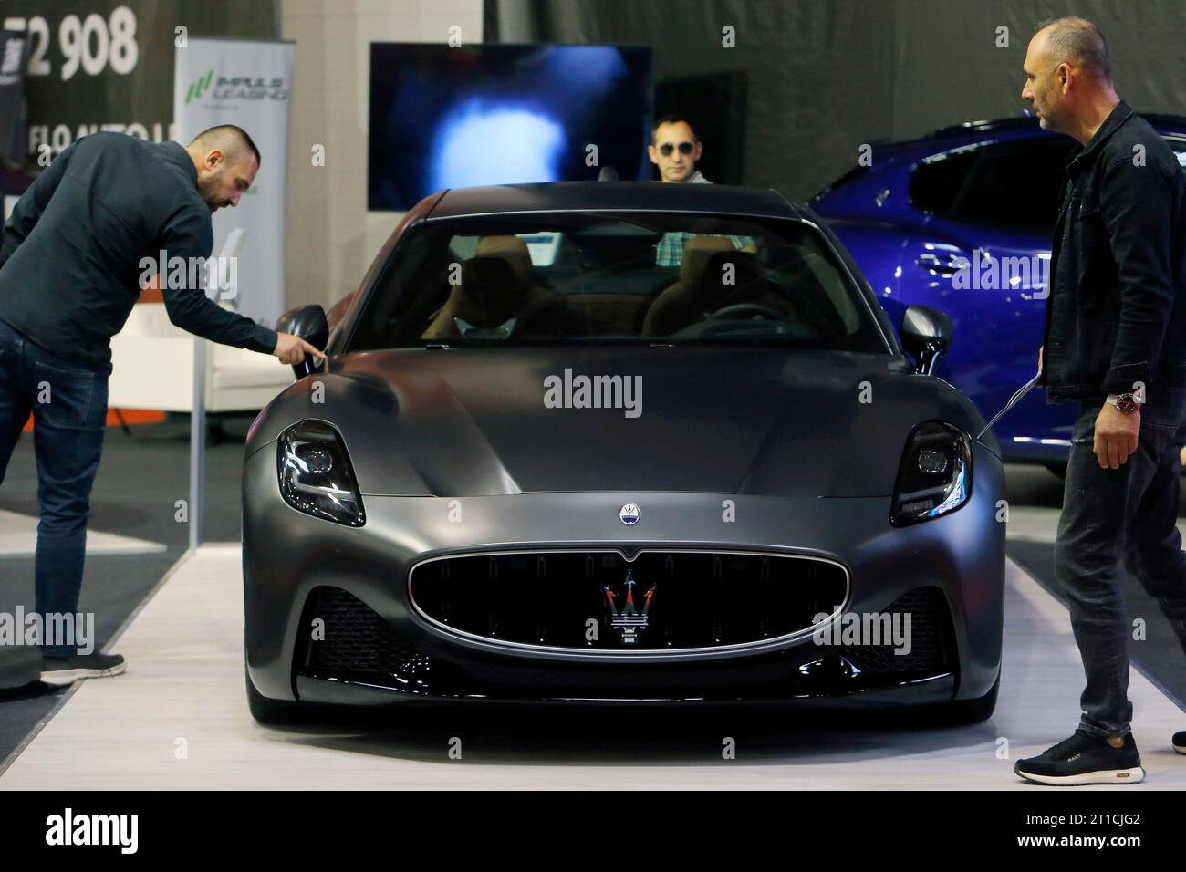 Bucharest, Romania. 12th Oct, 2023. Visitors look at a Maserati ...